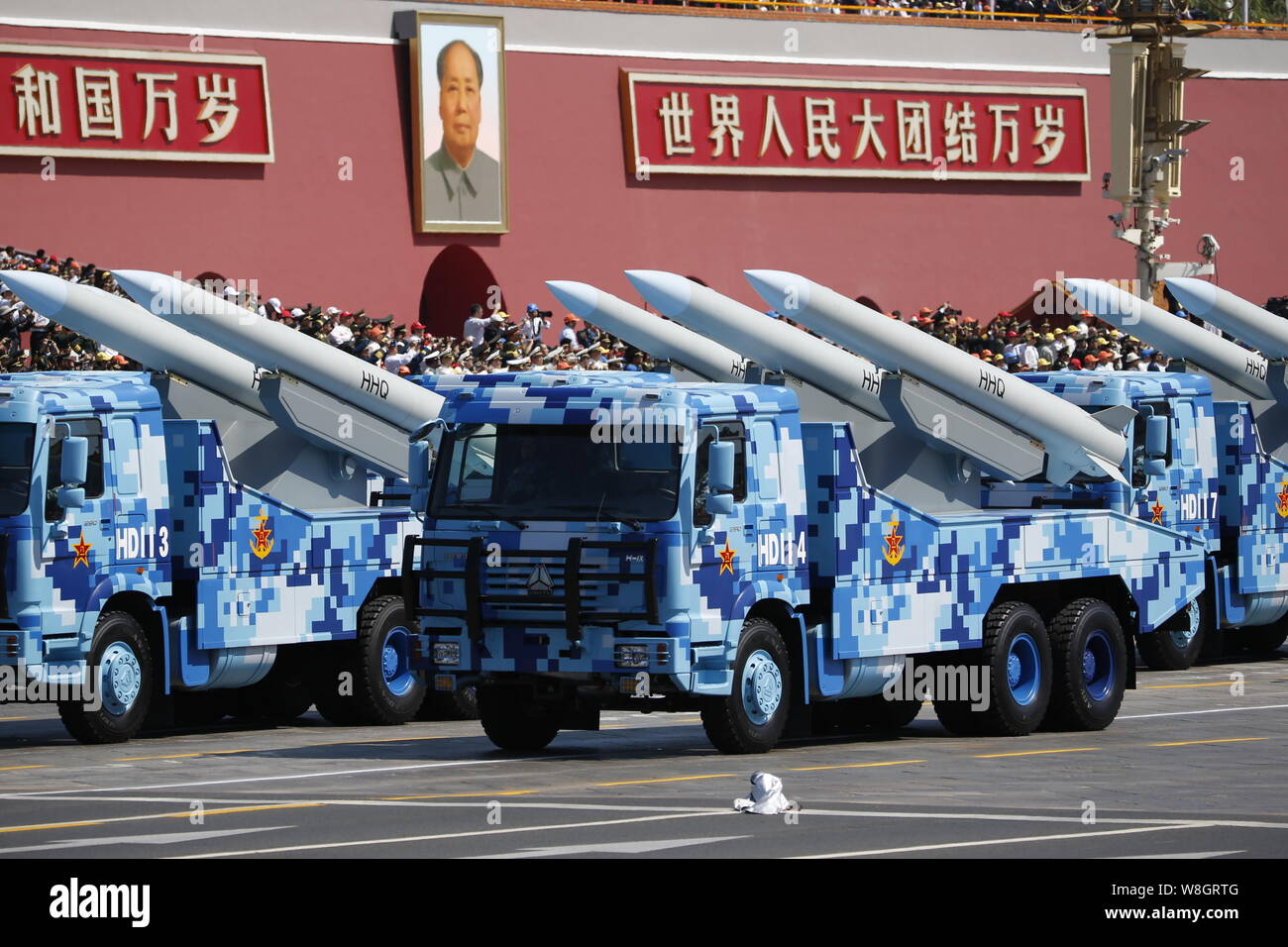 Military vehicles carrying HHQ-9 ship-to-air missiles march past the ...