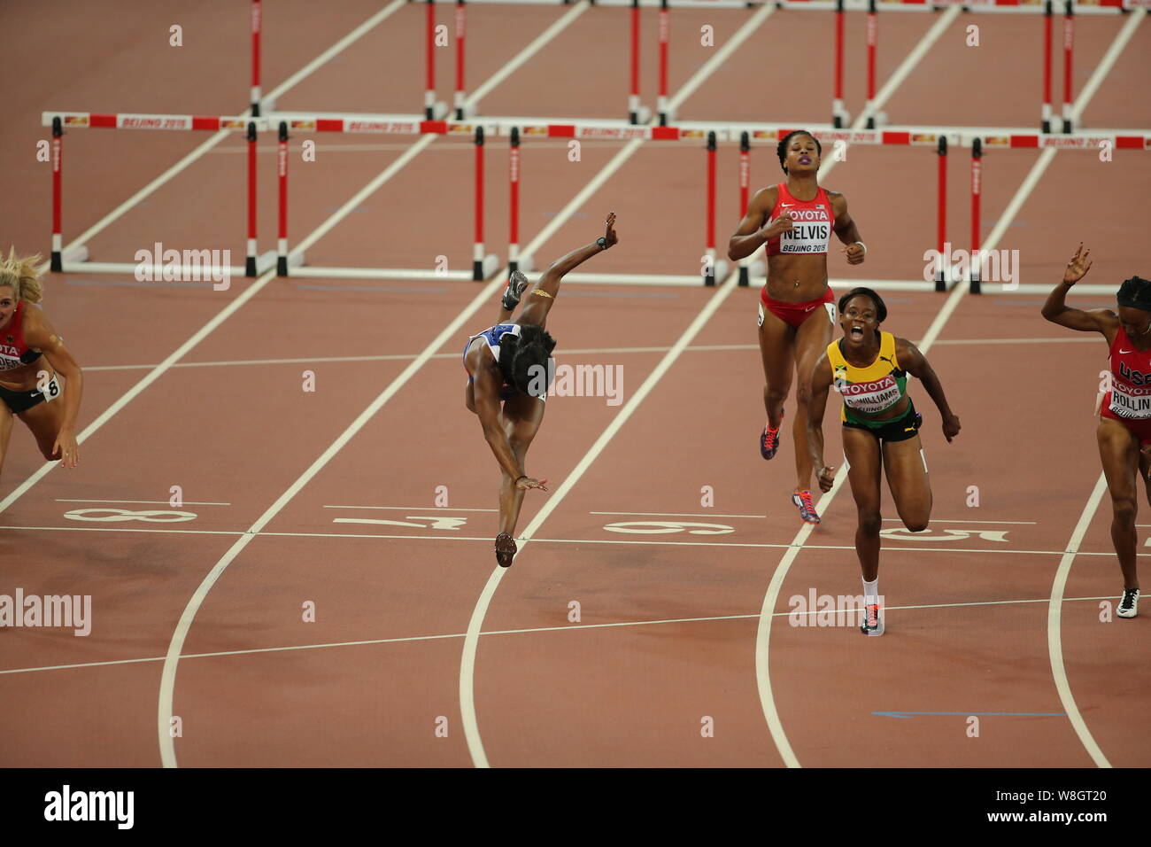 Jamaica's Danielle Williams, second right, crosses the finish line to ...