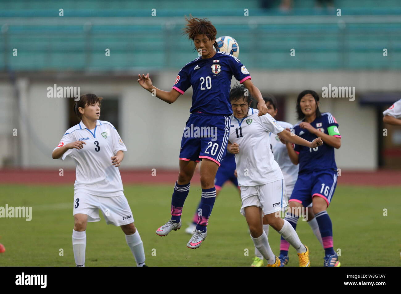 Akari Shiraki of Japan, center, challenges players of Uzbekistan in a ...