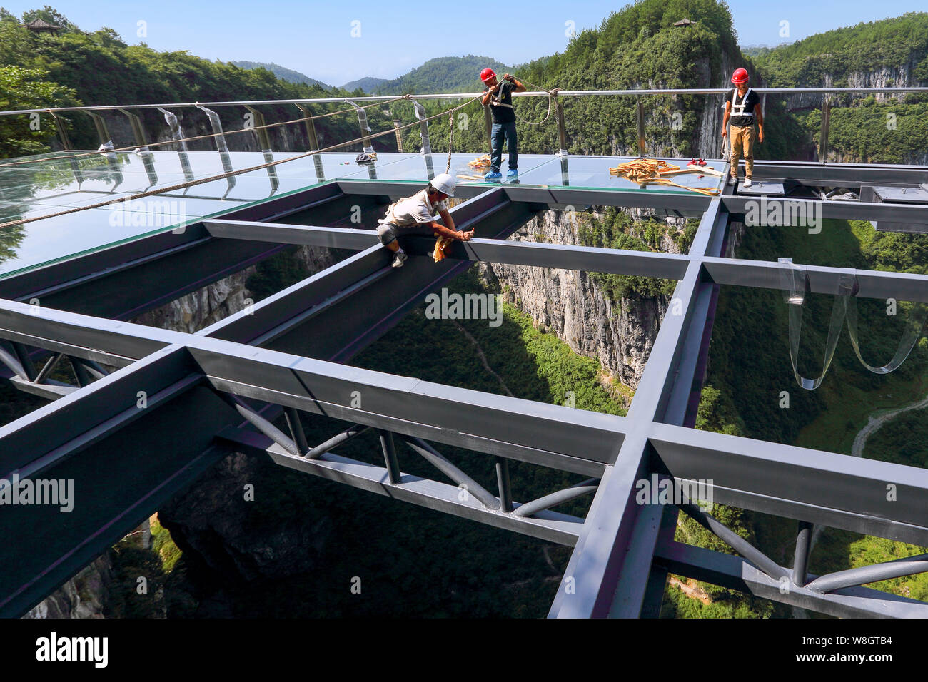 Chinese workers install the final piece of glass on the Asia's largest ...