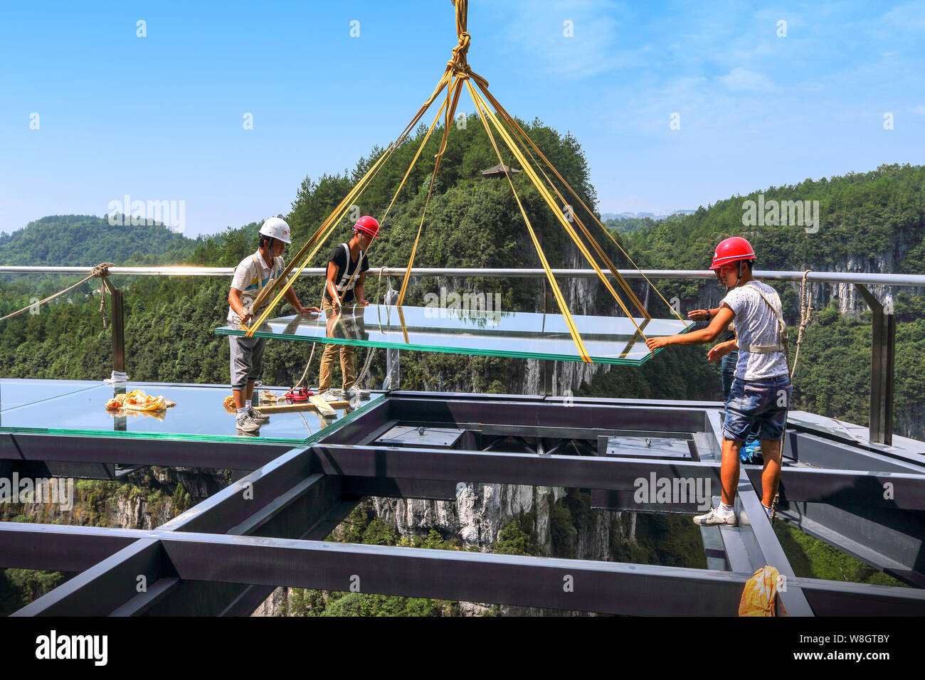 Chinese workers install the final piece of glass on the Asia's largest ...