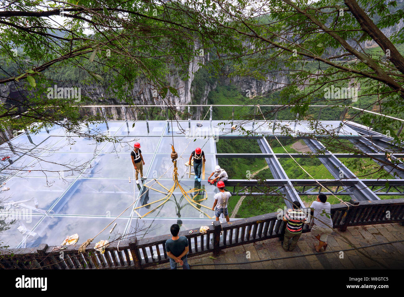Chinese workers install the final piece of glass on the Asia's largest ...