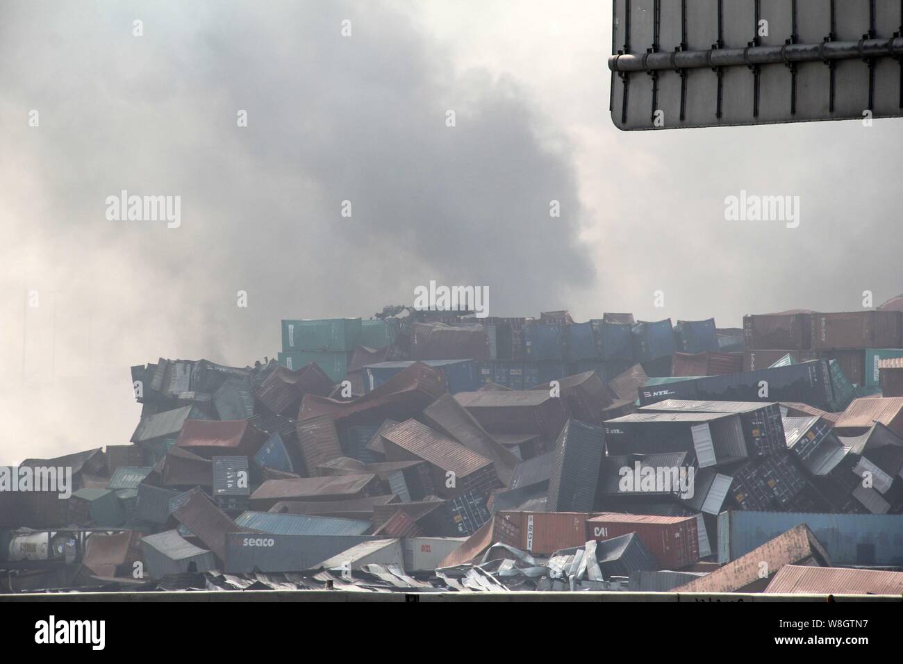 Overturned shipping containers are piled up in a container terminal ...