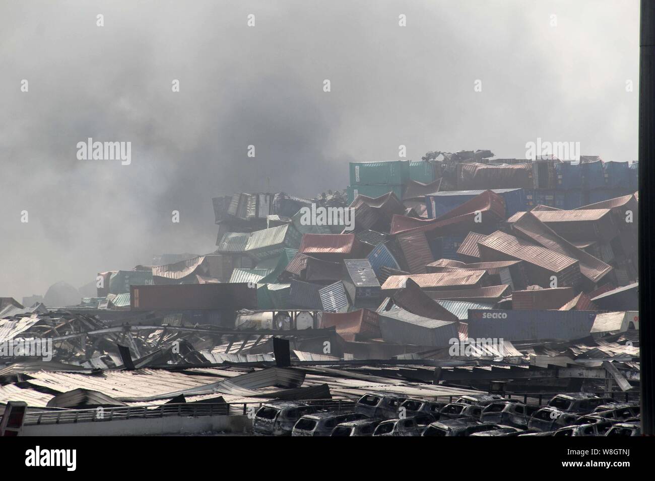 Overturned shipping containers are piled up in a container terminal ...