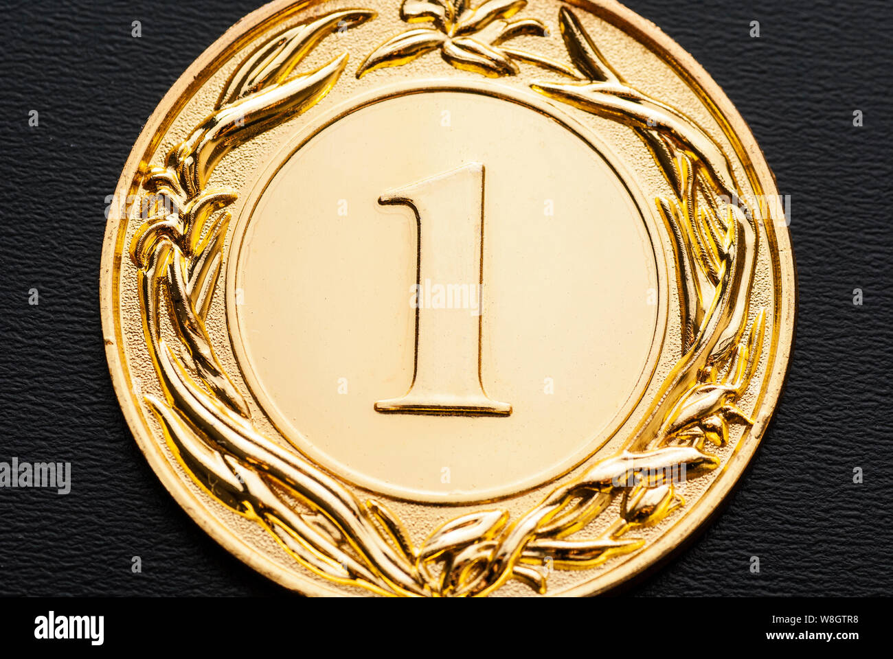Close-up of a golden medal for the number one champion as award and ...