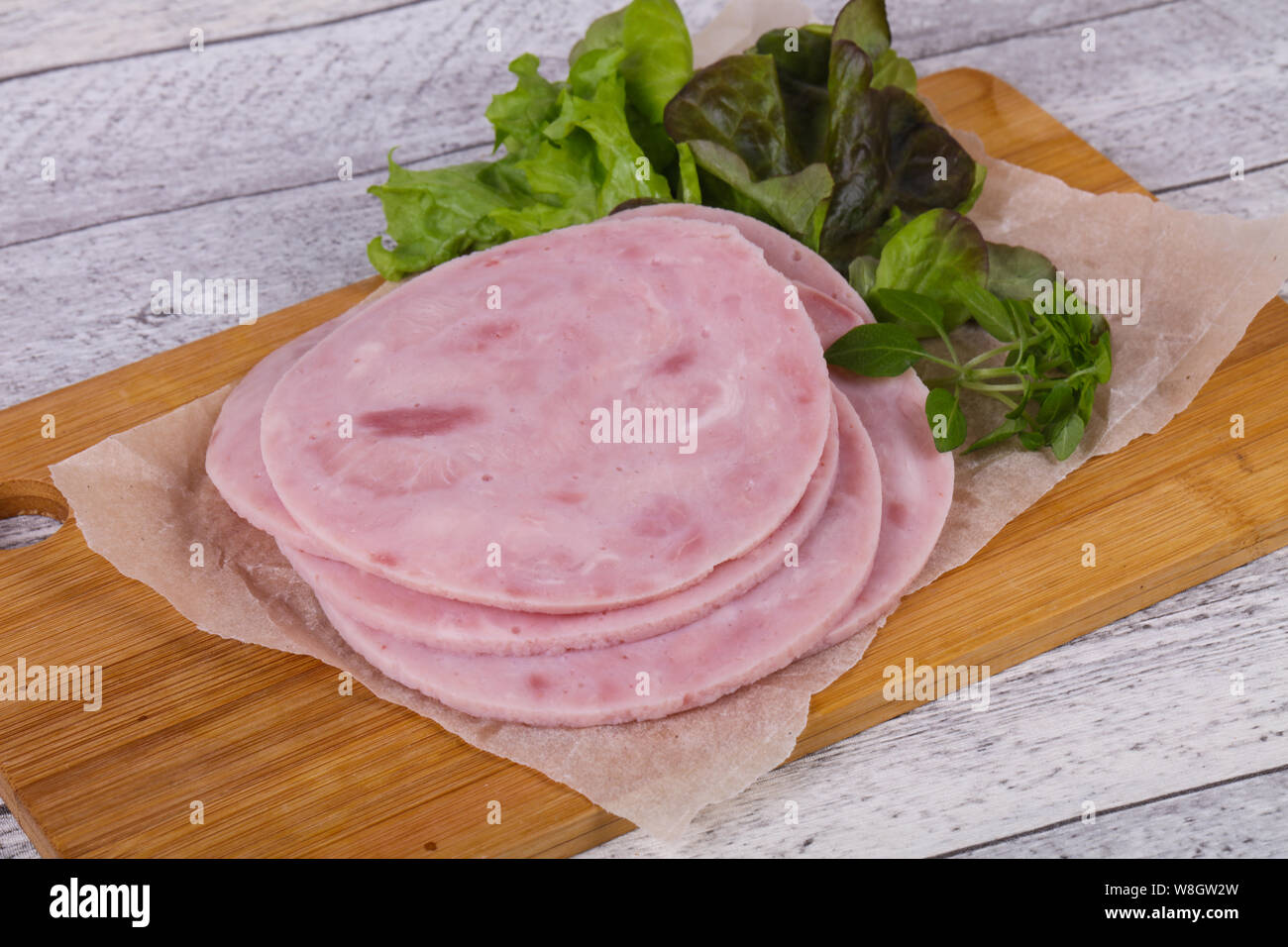Sliced tasty Ham appetizer served salad leaves Stock Photo - Alamy