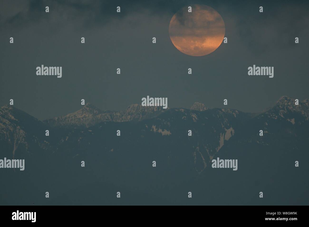 Beautiful shot of red moon above mountains Stock Photo - Alamy