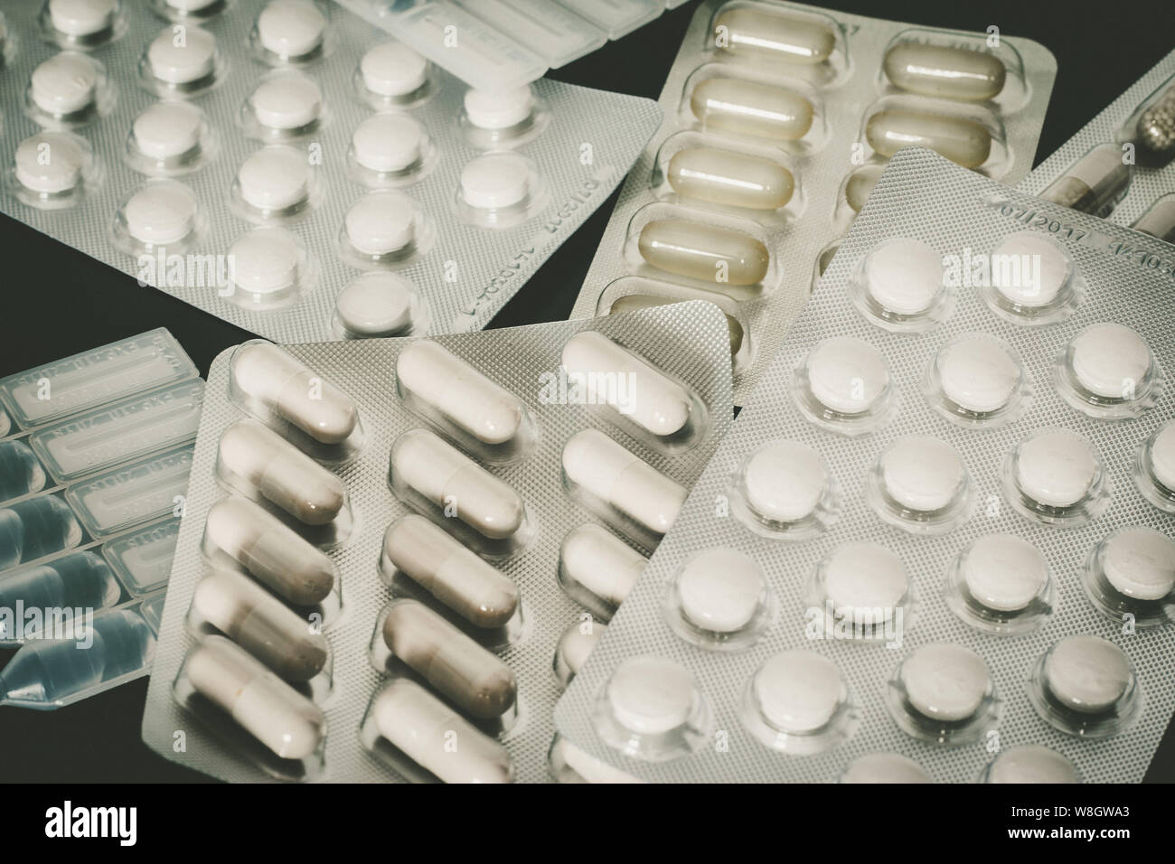 Pills or medicine lying on the grey table, drug abuse Stock Photo - Alamy