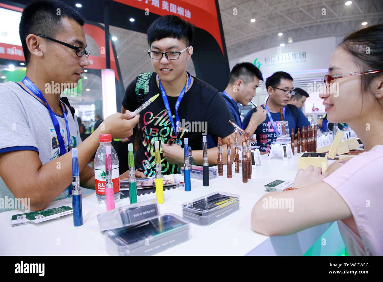 Visitors try e-cigarettes during the First Beijing International Vapor ...