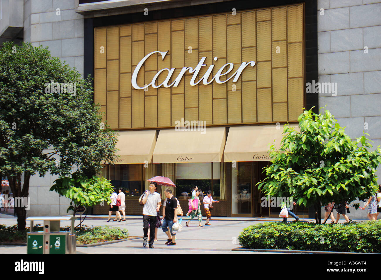 --FILE--Pedestrians walk past a boutique of Cartier in Chongqing, China ...