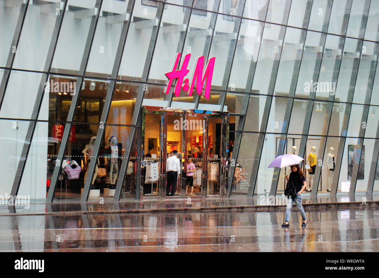 --FILE--A pedestrian walks past a store of H&M in Chongqing, China, 4 ...