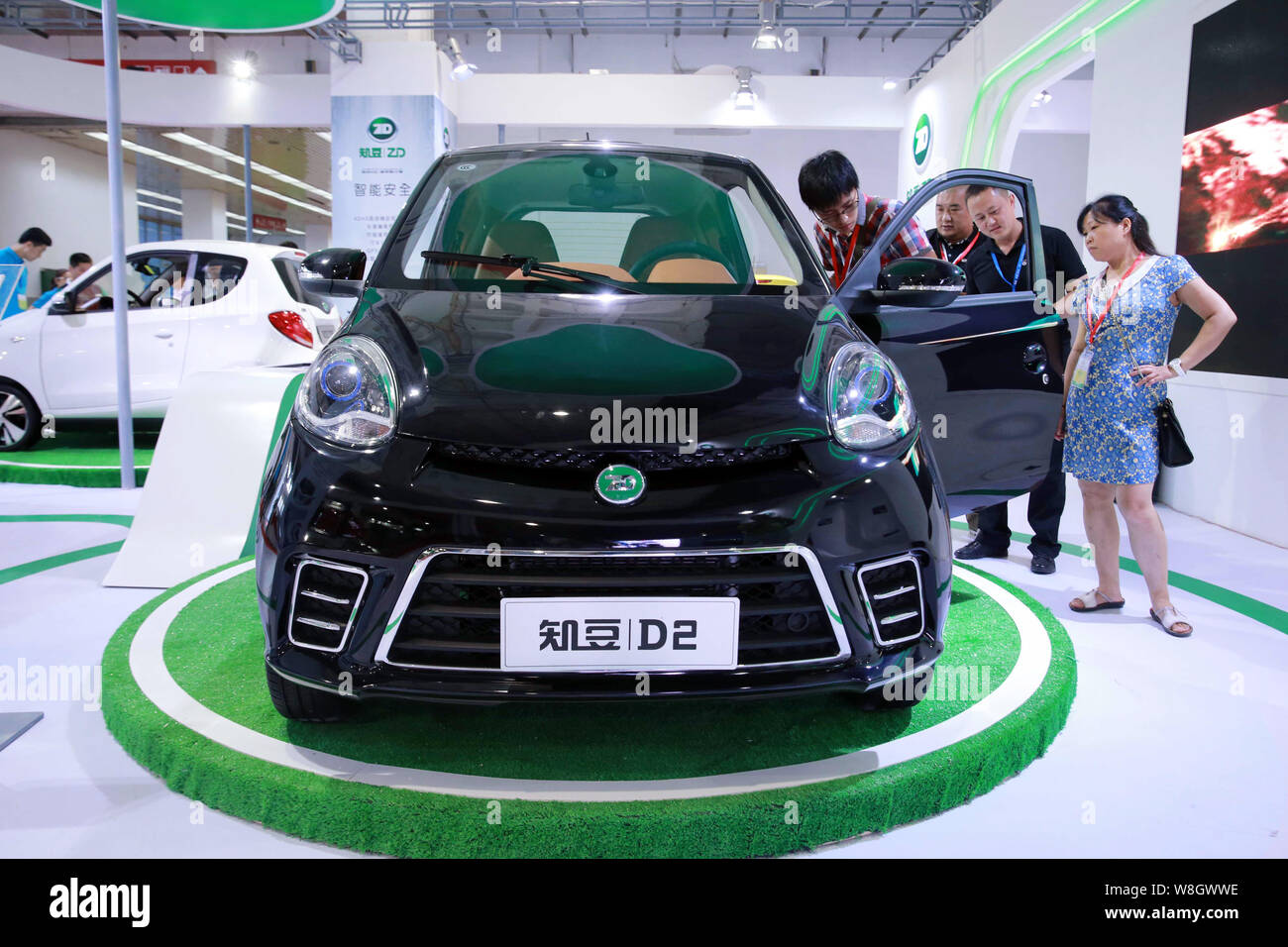 --FILE--Visitors look at a ZD D2 electric car on display during an ...