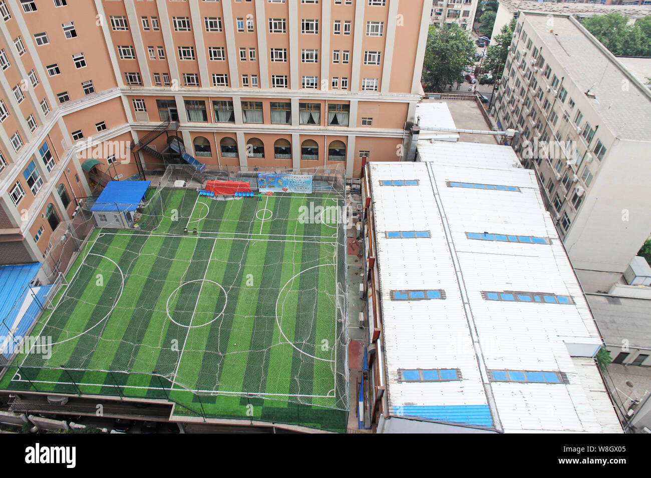 View of a football field on the rooftop of a two-story office building ...
