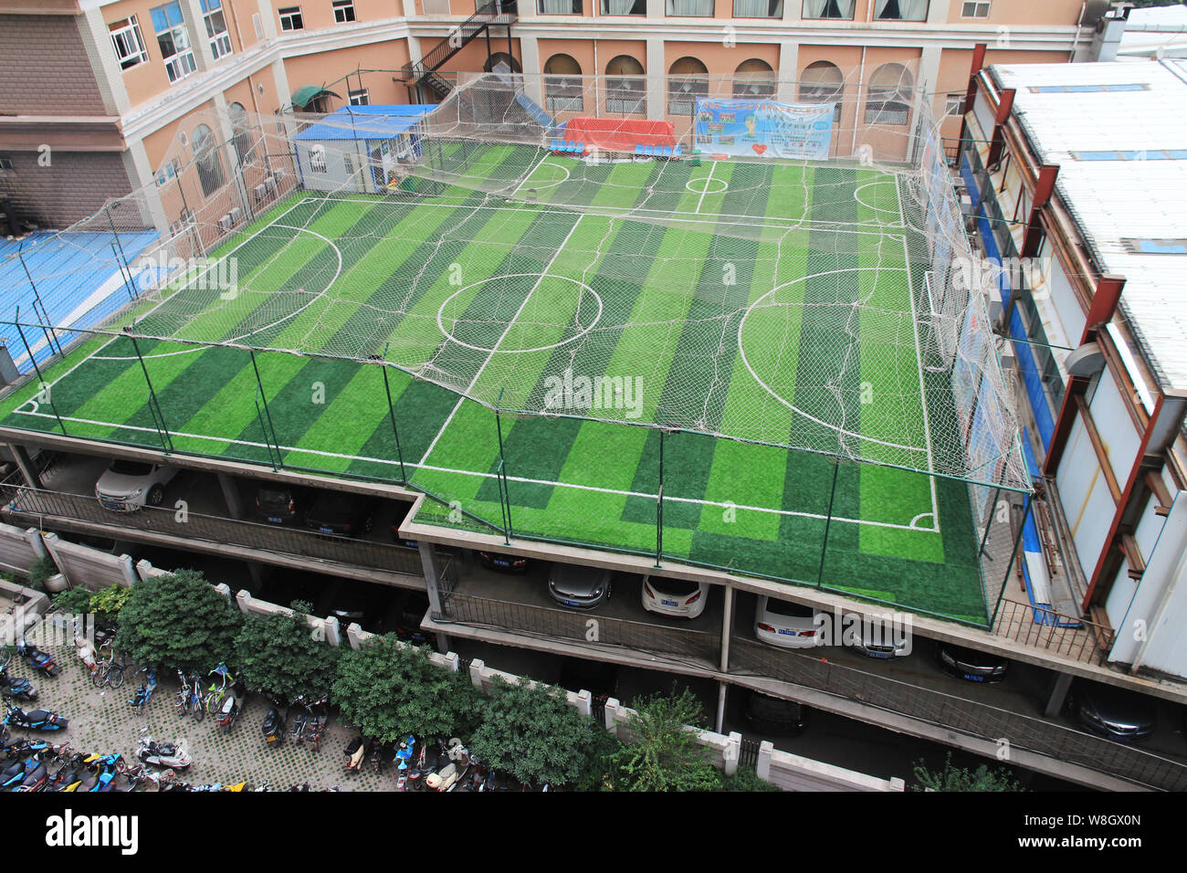 View of a football field on the rooftop of a two-story office building ...