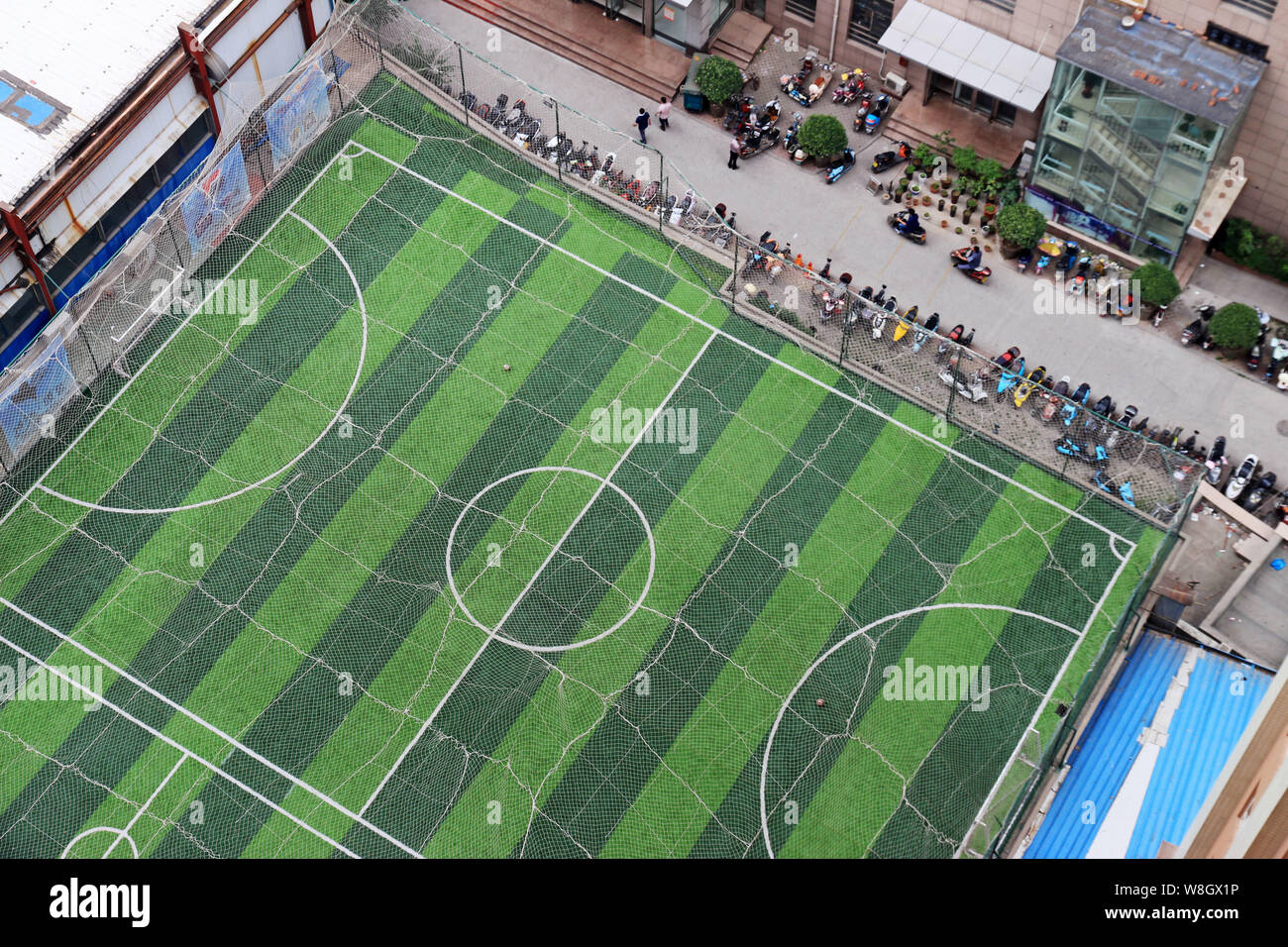 View of a football field on the rooftop of a two-story office building ...
