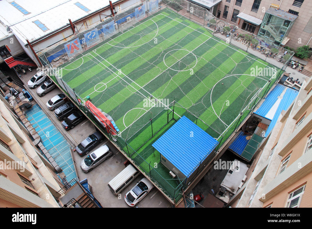 View of a football field on the rooftop of a two-story office building ...