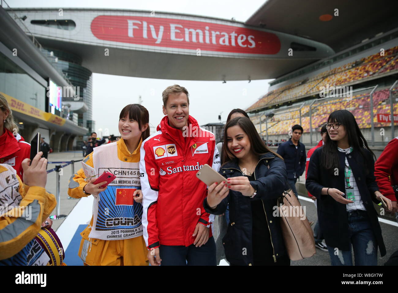 German F1 driver Sebastian Vettel of Ferrari, center, poses with fans ...