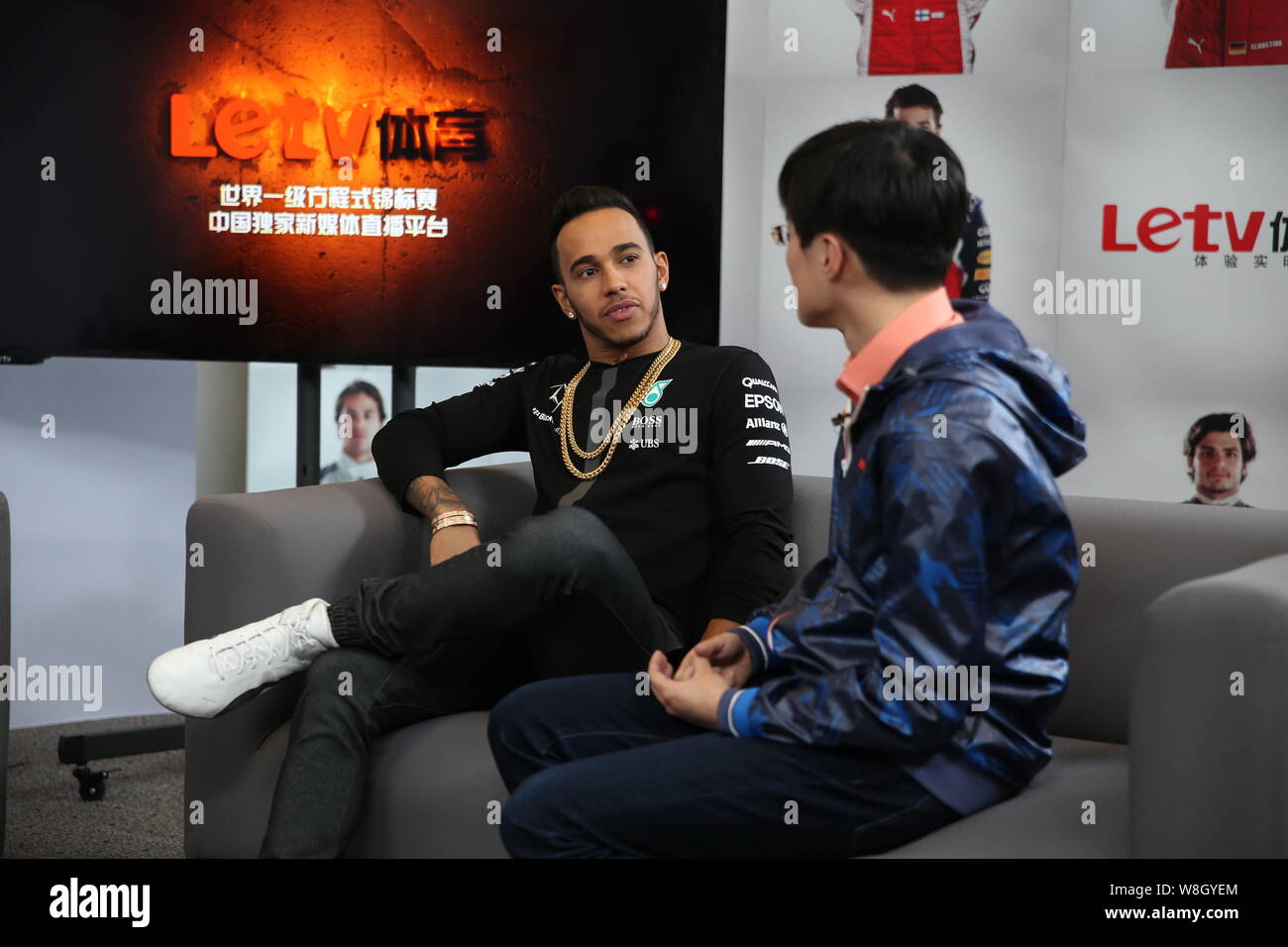 British F1 driver Lewis Hamilton of Mercedes AMG, left, speaks at an ...