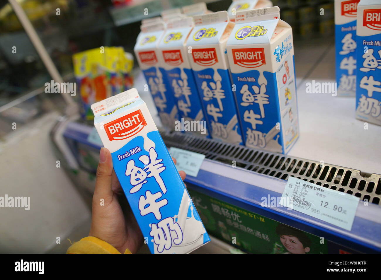 --FILE--A customer buys a carton of Bright fresh milk of Bright Food ...