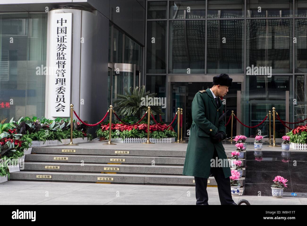 --FILE--A security guard is seen in front of the headquarters of the ...