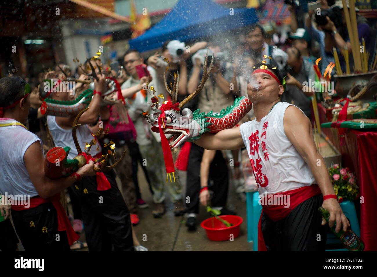 A performer sprays beer from his mouth to perform a drunken dragon dance during the Drunken ...