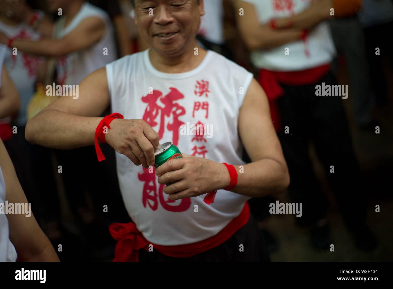 A performer opens a can of beer to perform a drunken dragon dance ...