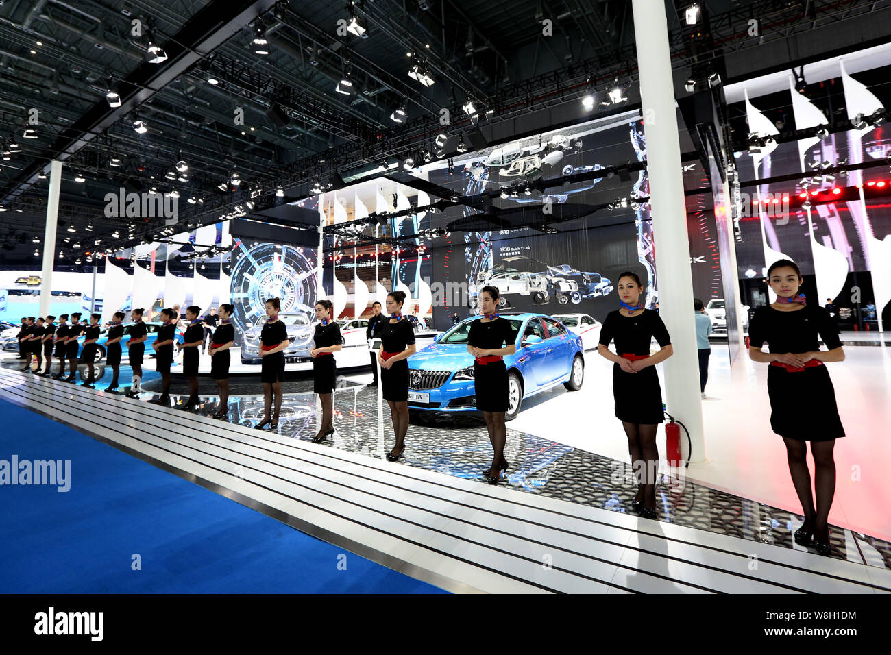 Hostesses pose in line at the stand of Buick of General Motors during ...