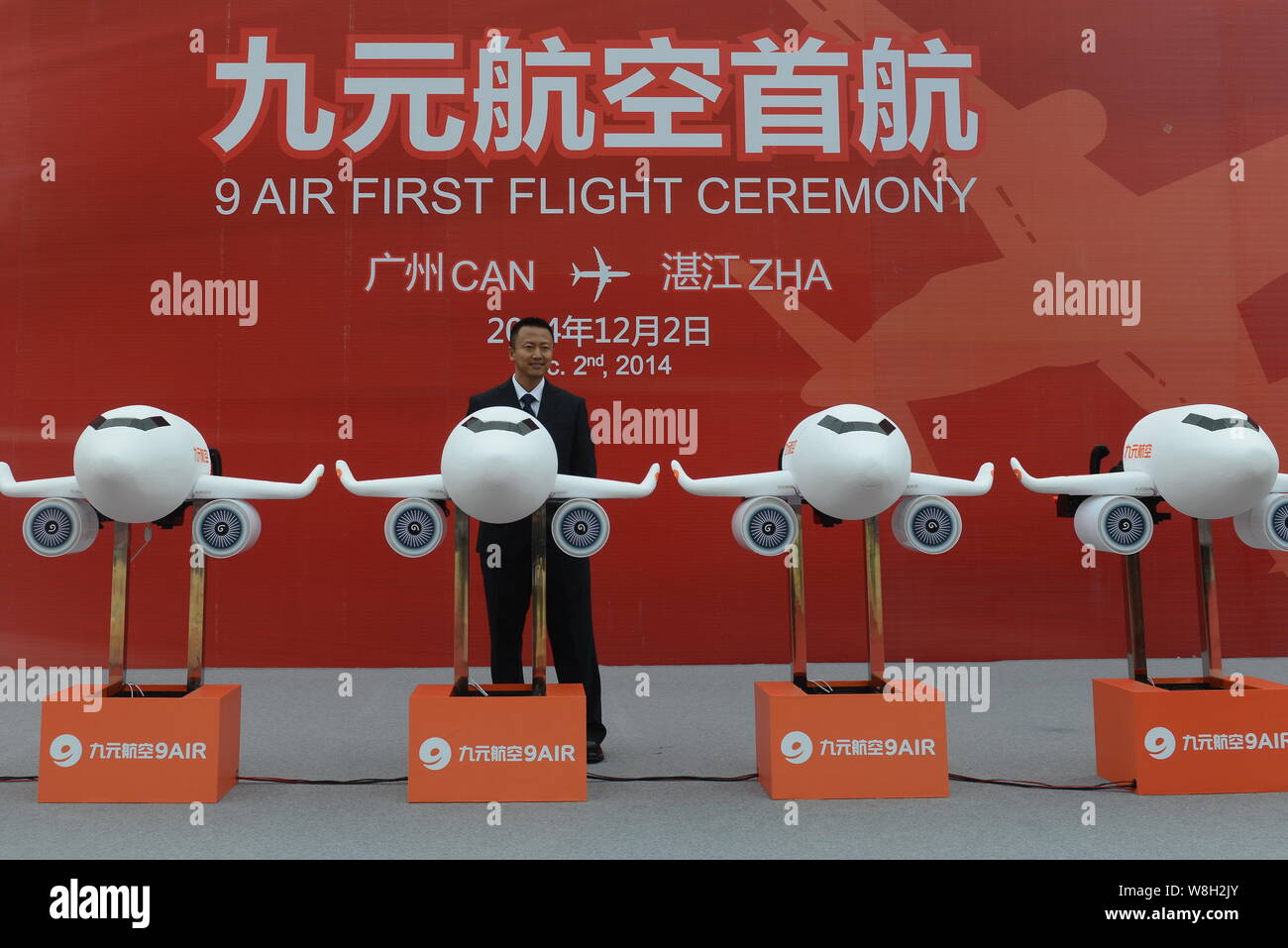 --FILE--A guest stands behind model planes during the 9 Air first ...