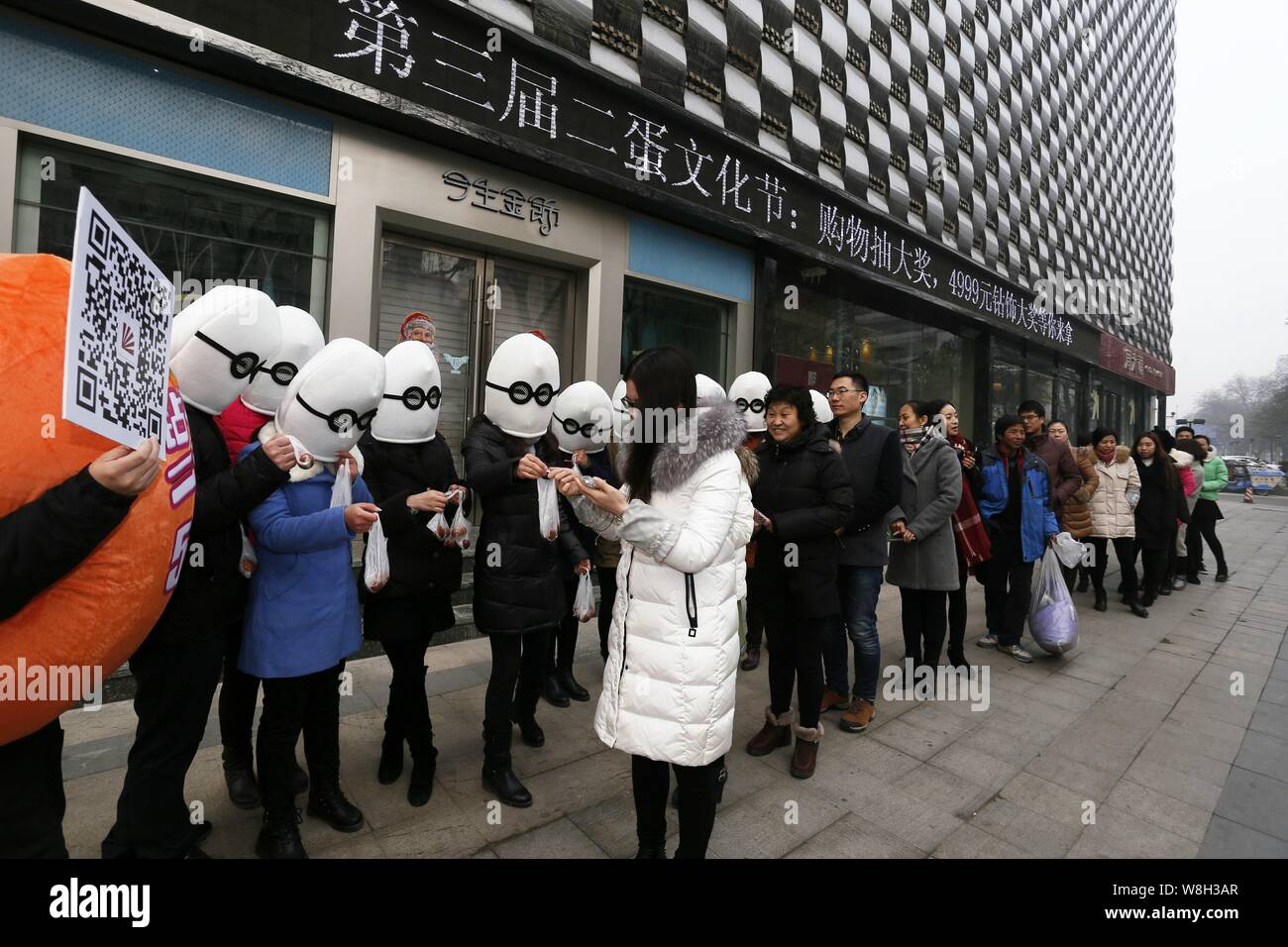 Female Chinese clerks from a jewelry store wearing egg-shaped helmets ...