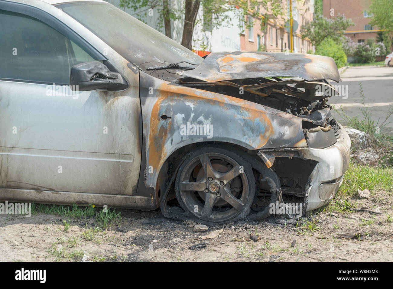 Burnt car on the street. Side view Stock Photo - Alamy