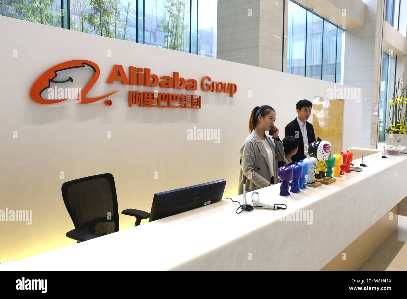 --FILE--Chinese employees are seen at the front desk of Alibaba Group ...