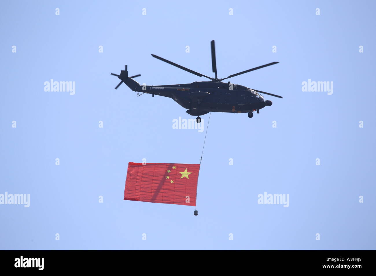 A military helicopter flies over Tiananmen Square during the military ...