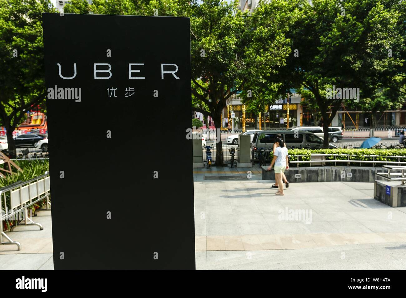 --FILE--A signboard of taxi-hailing app Uber is pictured on a road in ...