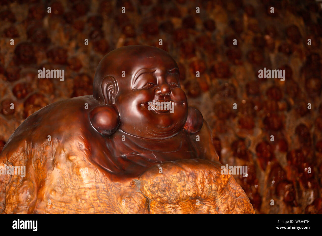 Wooden Buddha statues are on display at an exhibition center in ...