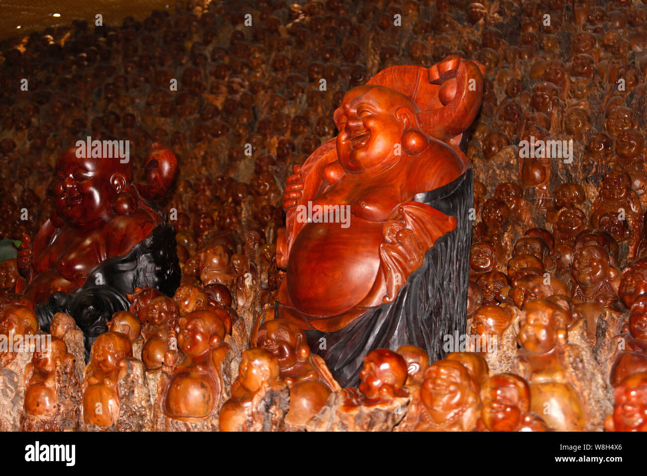Wooden Buddha statues are on display at an exhibition center in ...