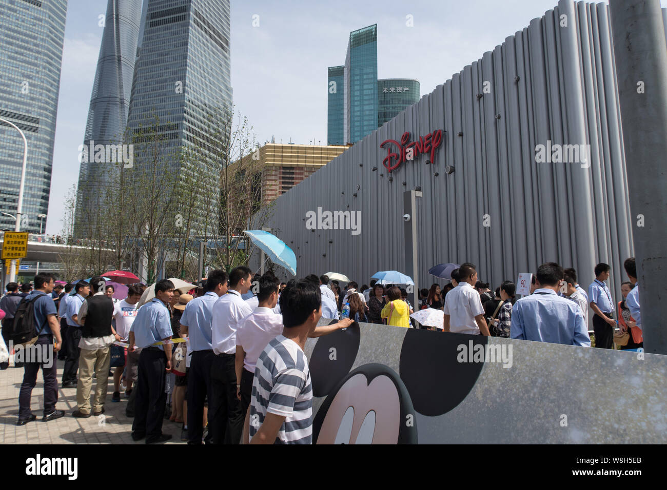 Customers queue up in front of the newly-opened Shanghai Disney ...