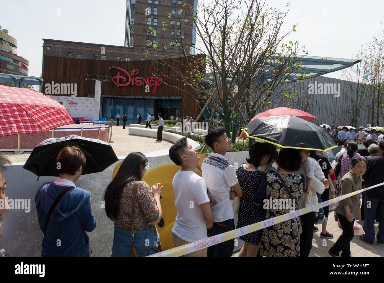 Customers queue up in front of the newly-opened Shanghai Disney ...