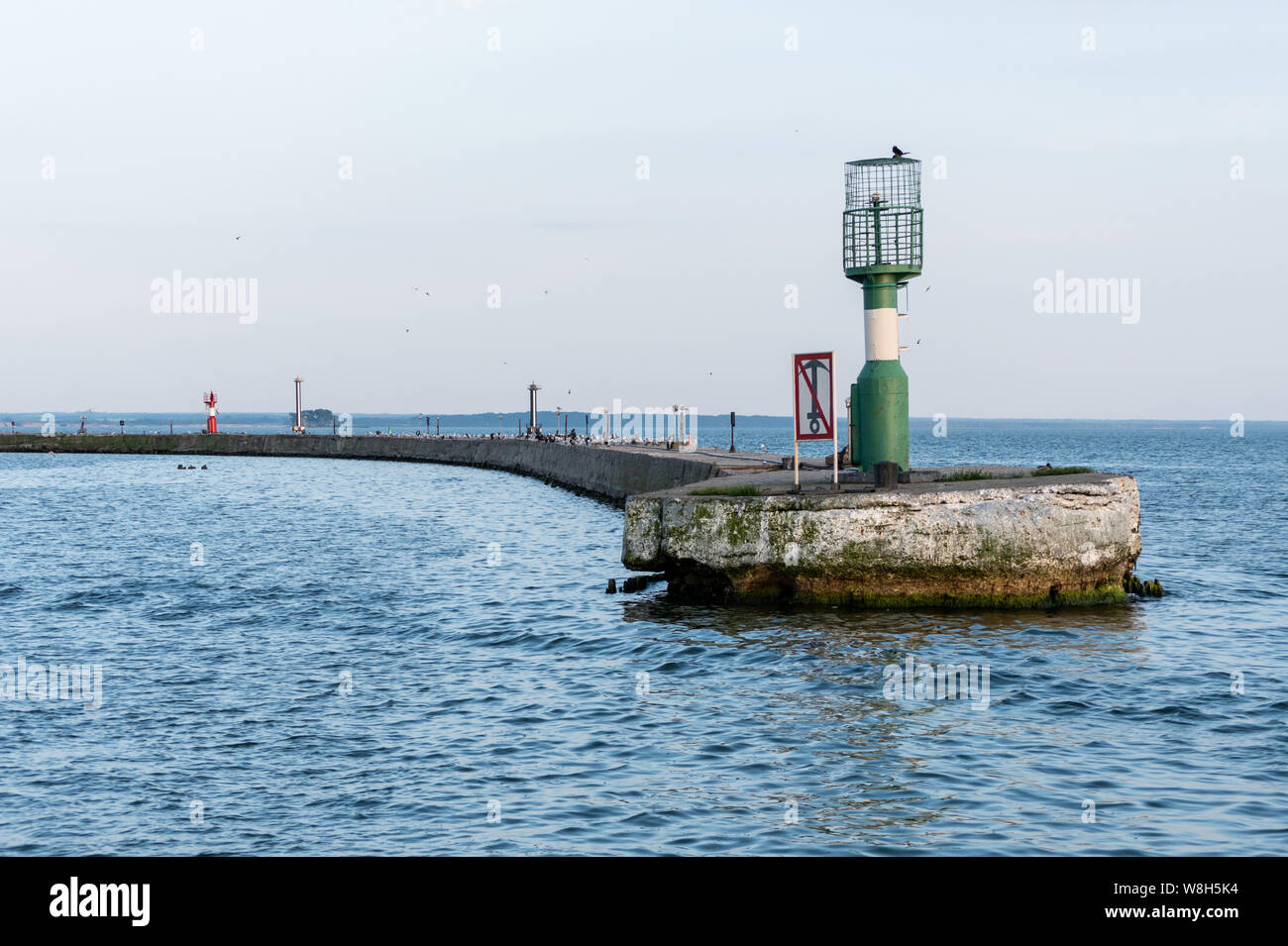 Jetty near seaport with modern lighthouse buoys. Beautiful seascape ...