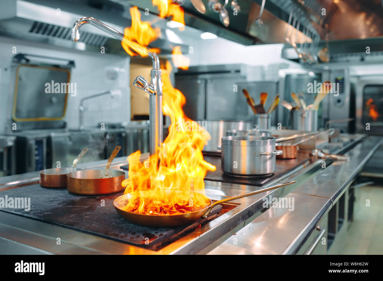 Modern kitchen. Cooks prepare meals on the stove in the kitchen of the ...