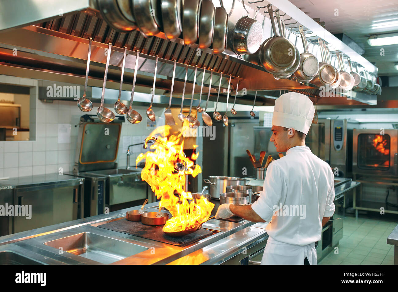 Modern kitchen. Cooks prepare meals on the stove in the kitchen of the ...