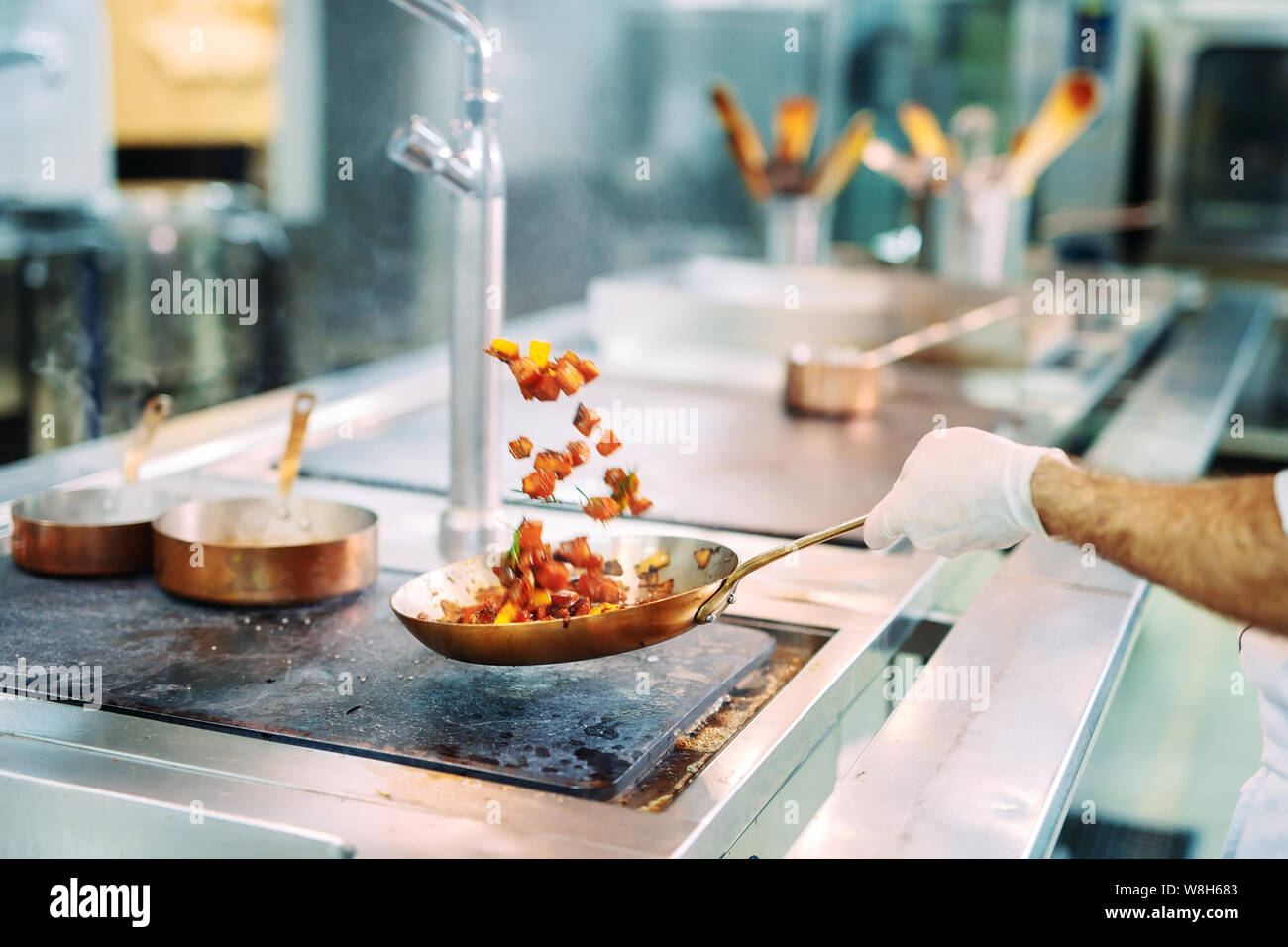 Chef cooking vegetables in wok pan. Shallow dof Stock Photo - Alamy