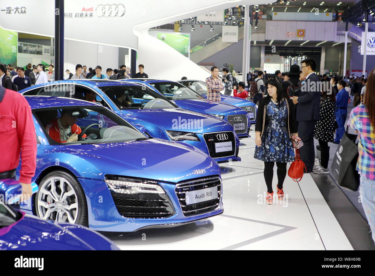 --FILE--Visitors try out or look at Audi cars on display during the ...