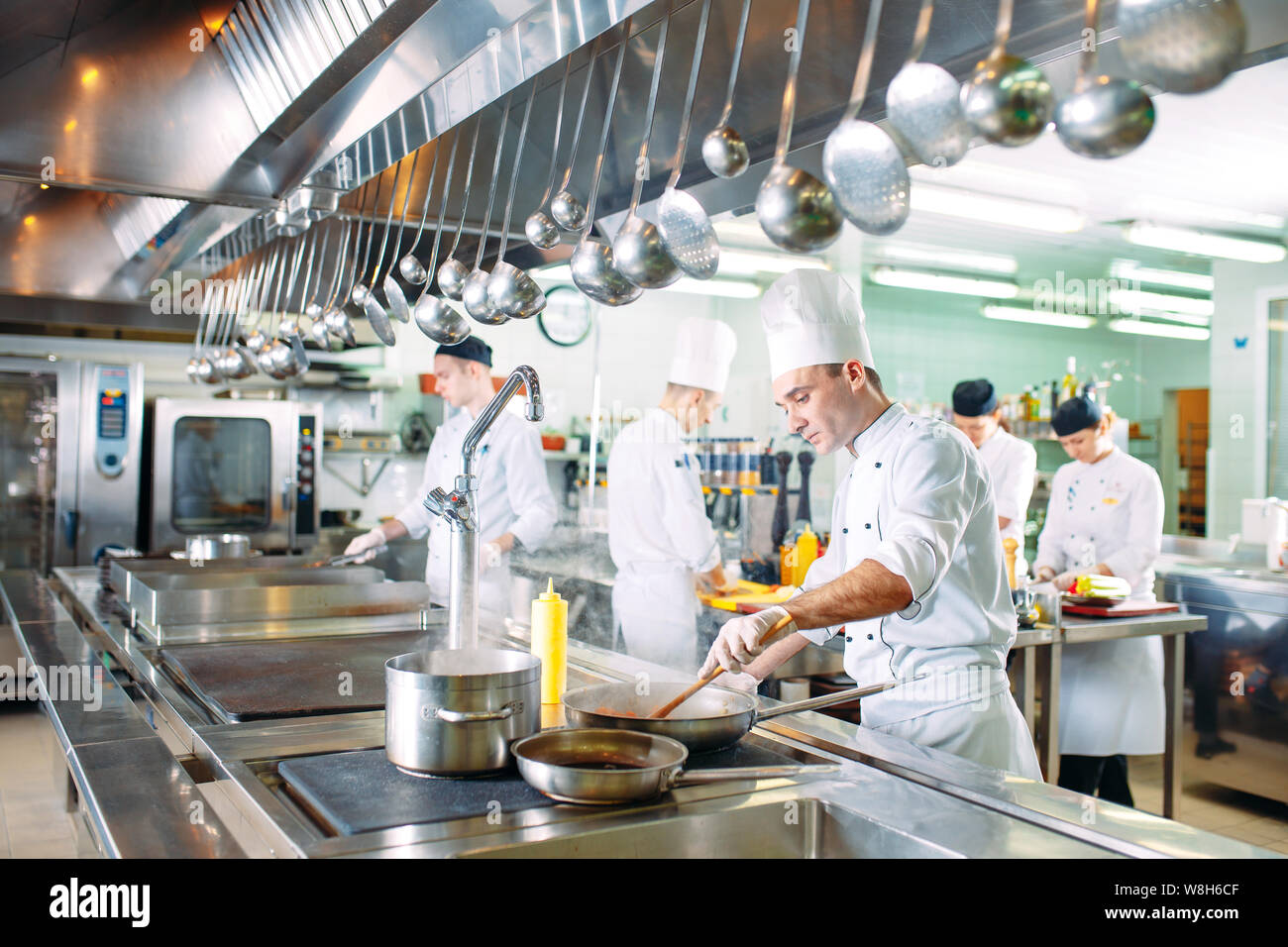 Modern kitchen. The chefs prepare meals in the restaurant's kitchen ...