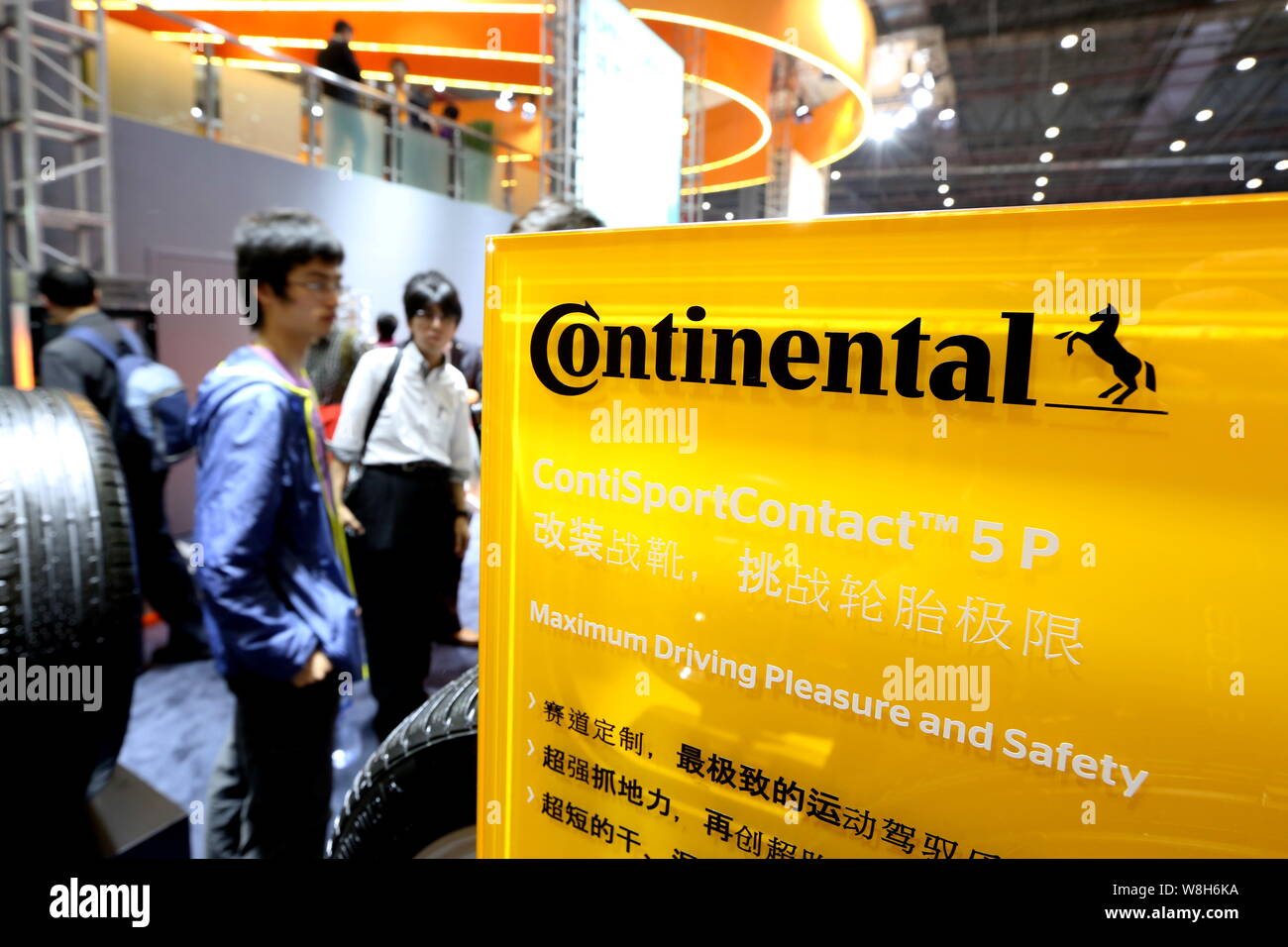 --FILE--Visitors look at car tires of Continental on display during the ...