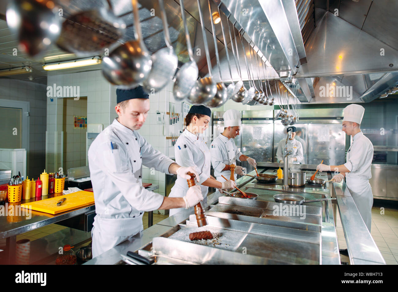 Modern kitchen. The chefs prepare meals in the restaurant's kitchen ...