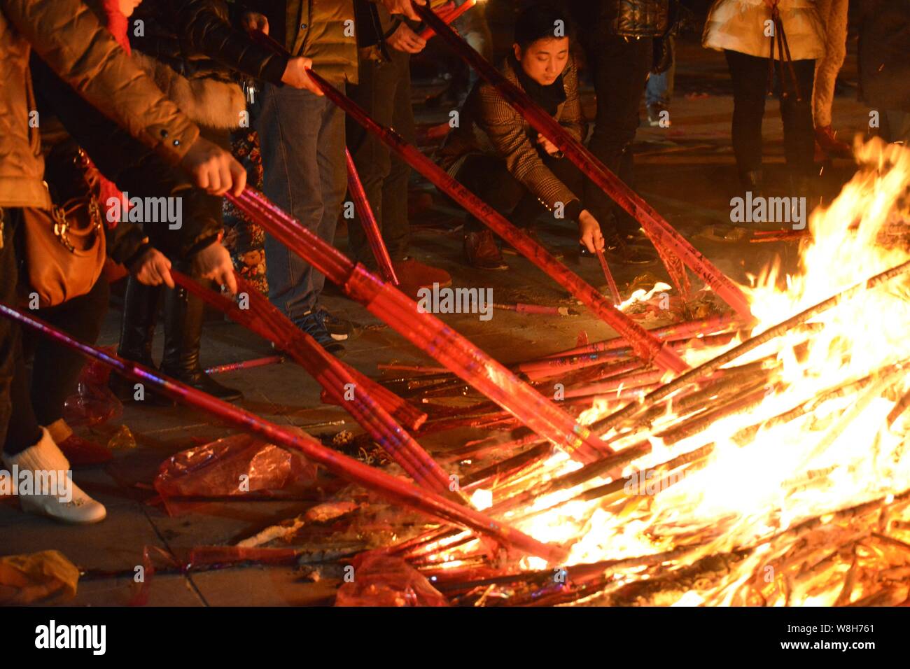 Chinese worshippers burn incense sticks to pray for good fortune and ...