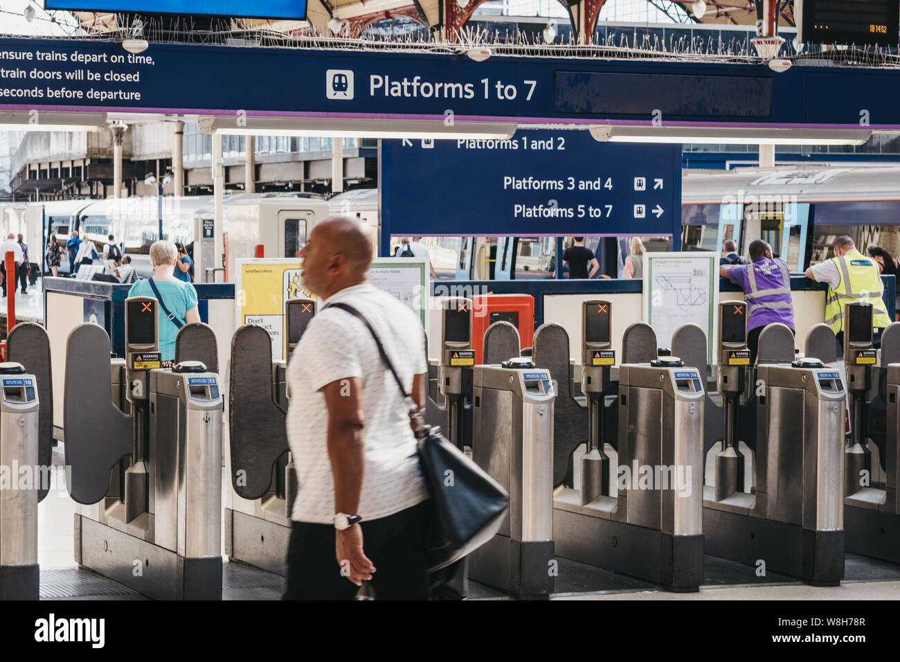 London, UK - July 16, 2019: Man walking past ticket gates inside ...