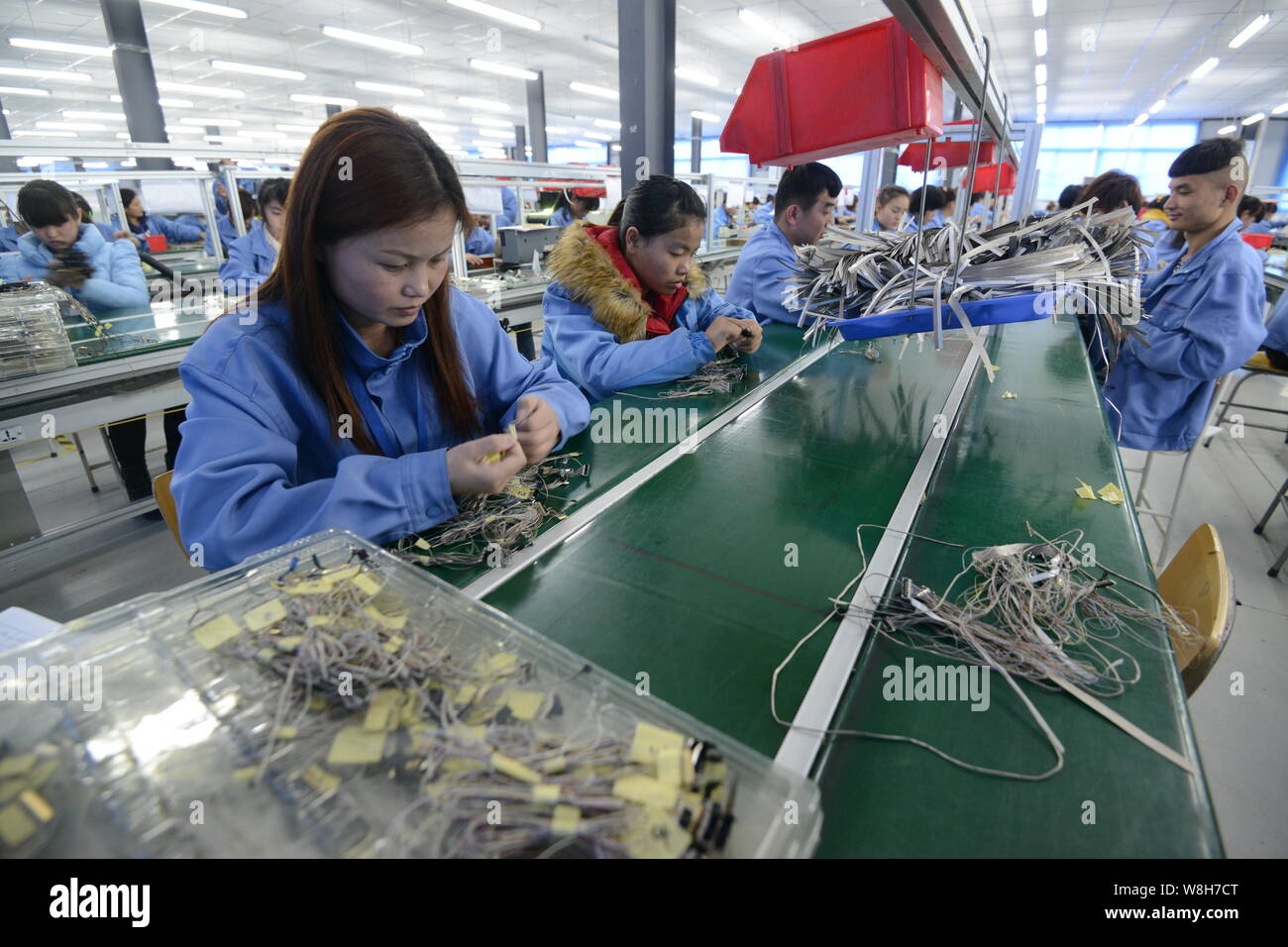 Female Chinese workers produce electronic accessories on the assembly ...