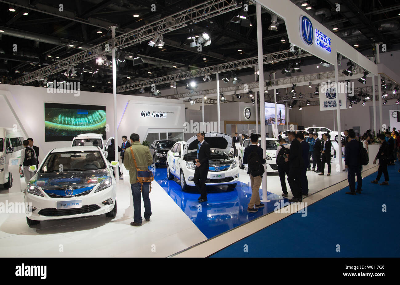 --FILE--Visitors look at cars at a stand of Changan Auto during an auto ...