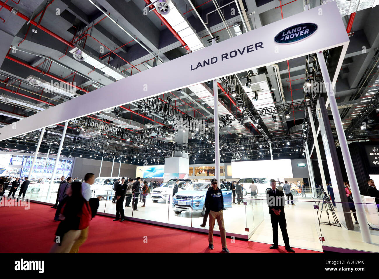 --FILE--Visitors look at Land Rover and Range Rover SUVs on display ...